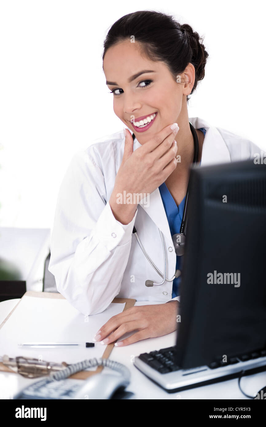 Female doctor portrait smiling and looking computer on white background ...