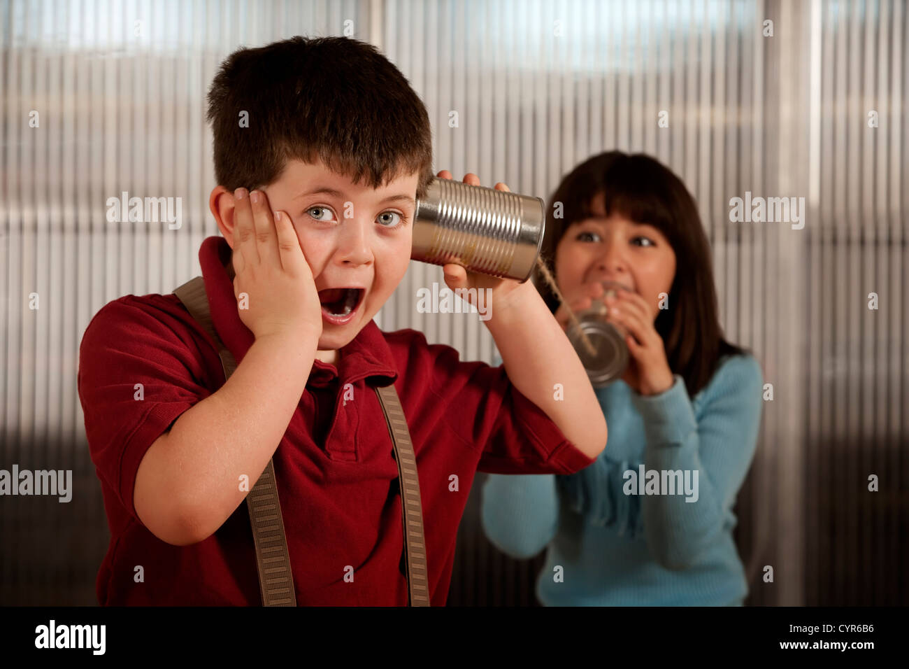 Little boy getting shocking message from girl on tin can phone Stock ...