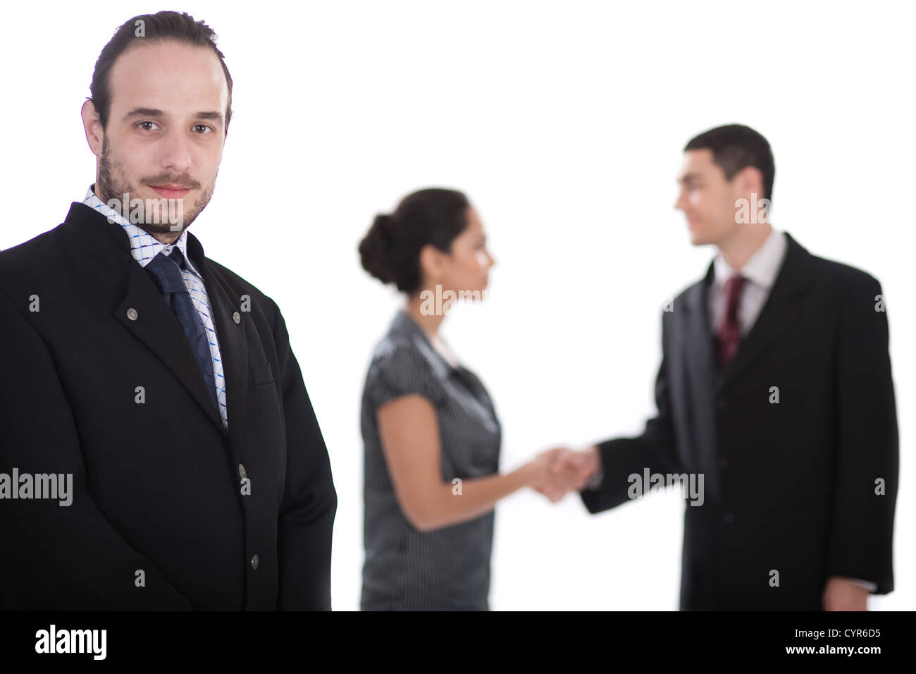 Handsome business man looking at us, two collegues giving shakehand out ...