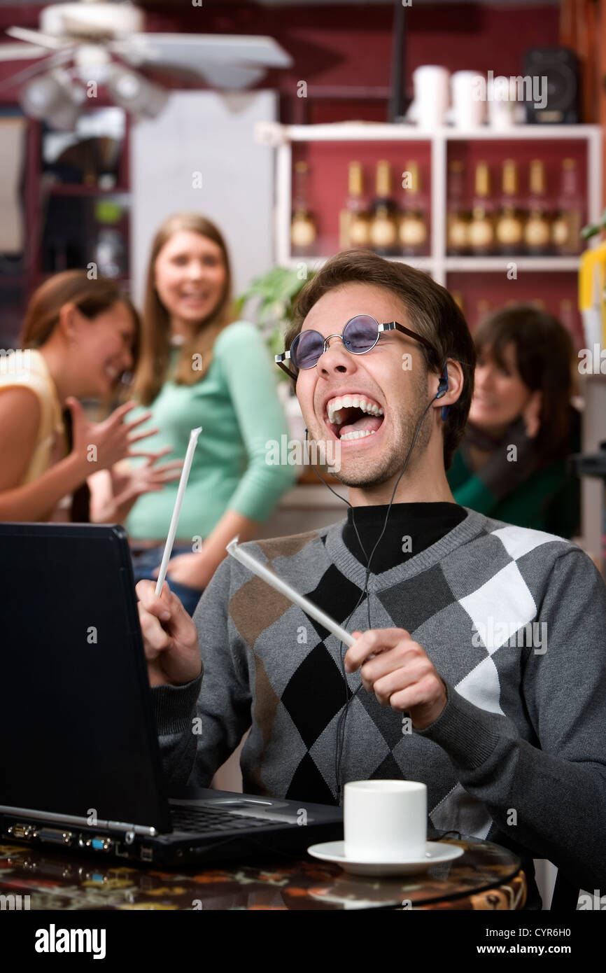 Obnoxious young man singing loudly in a coffee house Stock Photo - Alamy