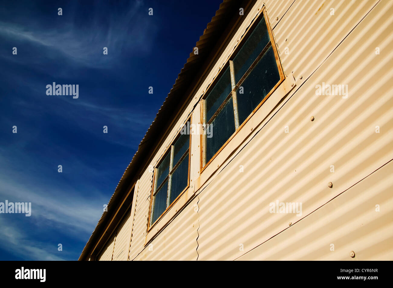 Windows on an old currugated metal building Stock Photo - Alamy