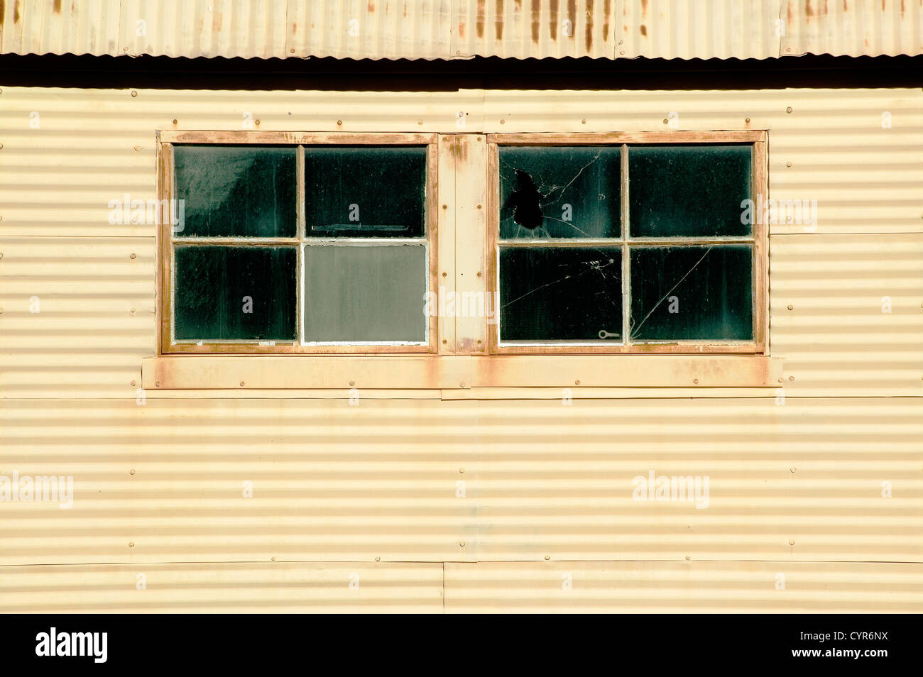 Windows on an old currugated metal building Stock Photo - Alamy