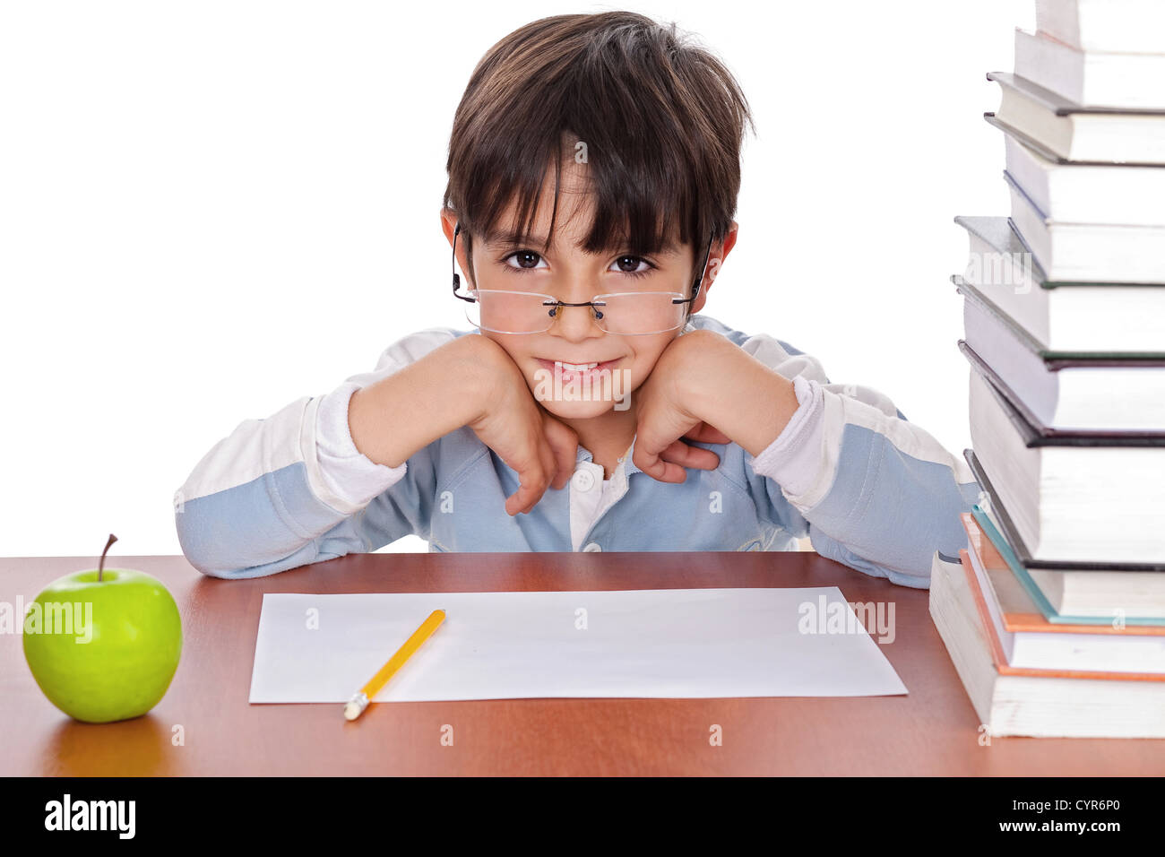 Studying young boy gives strange look wearing specs over isolated ...