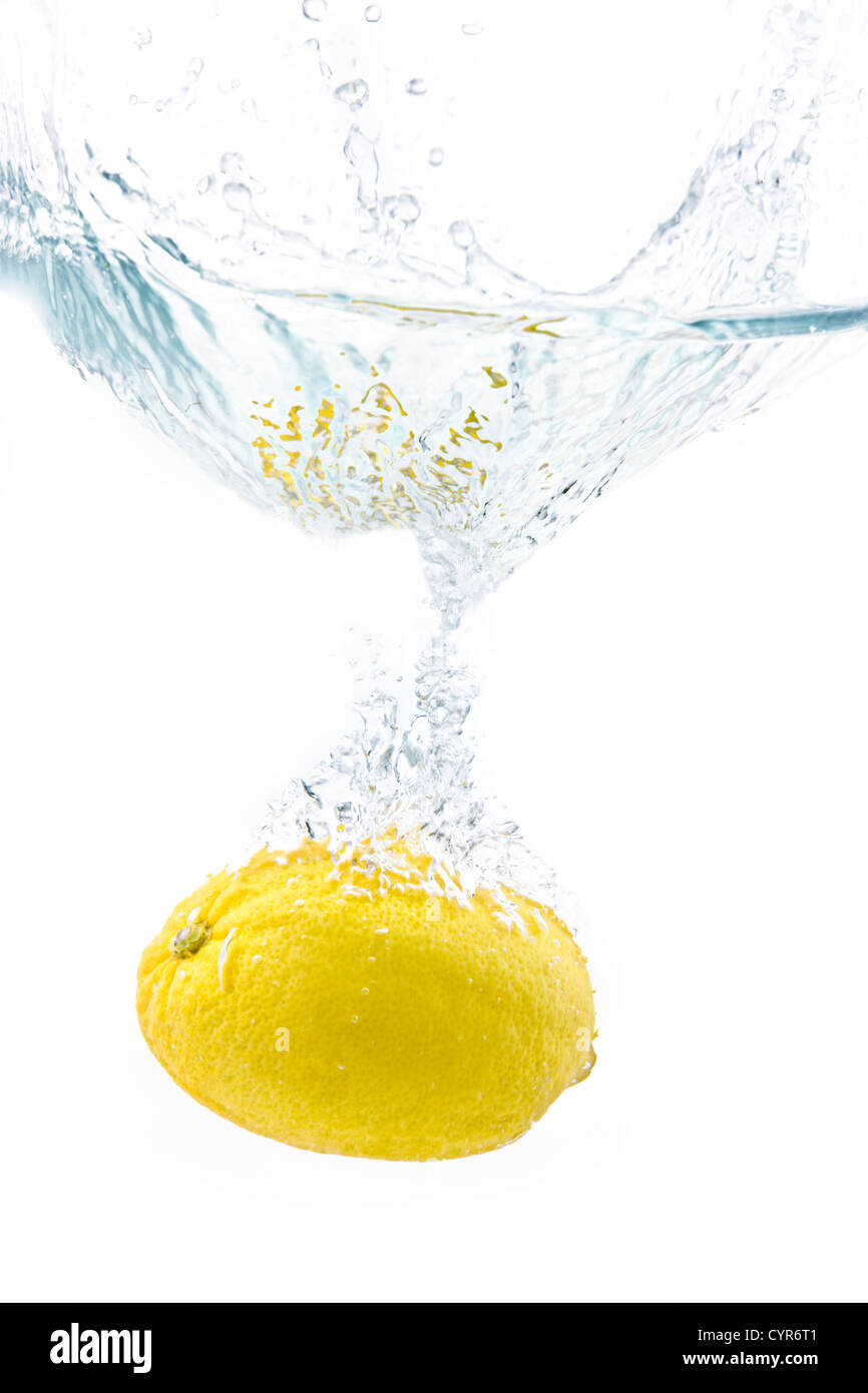 Fresh large lemon splashing into water with white background Stock ...