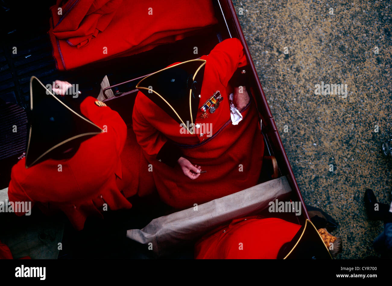 Chelsea Pensioners sit on board an open-top bus as they prepare to ...