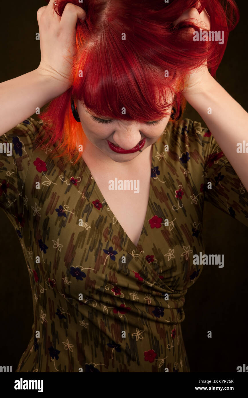 Pretty punky girl with brightly dyed red hair Stock Photo - Alamy