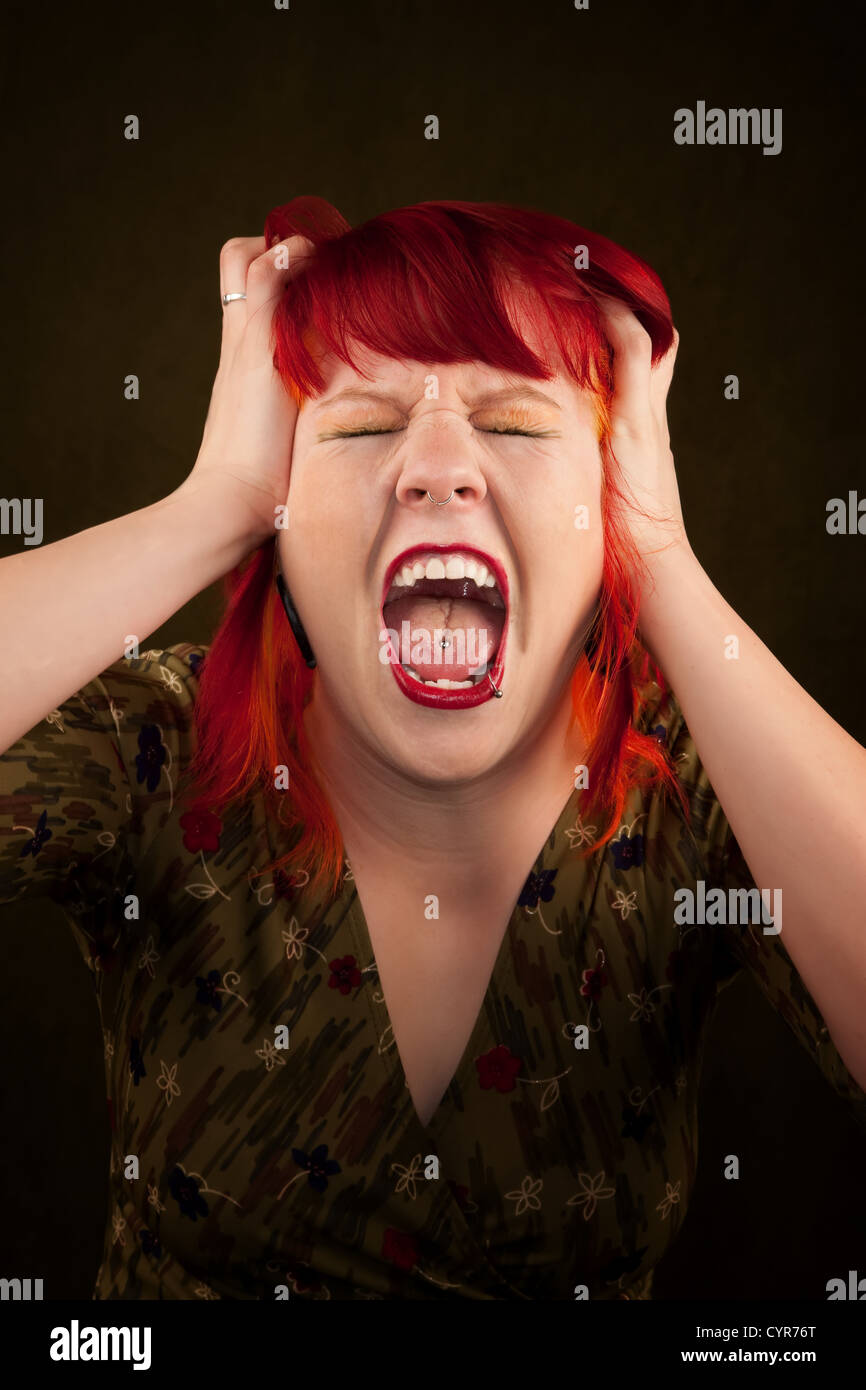Pretty punky girl with brightly dyed red hair Stock Photo - Alamy
