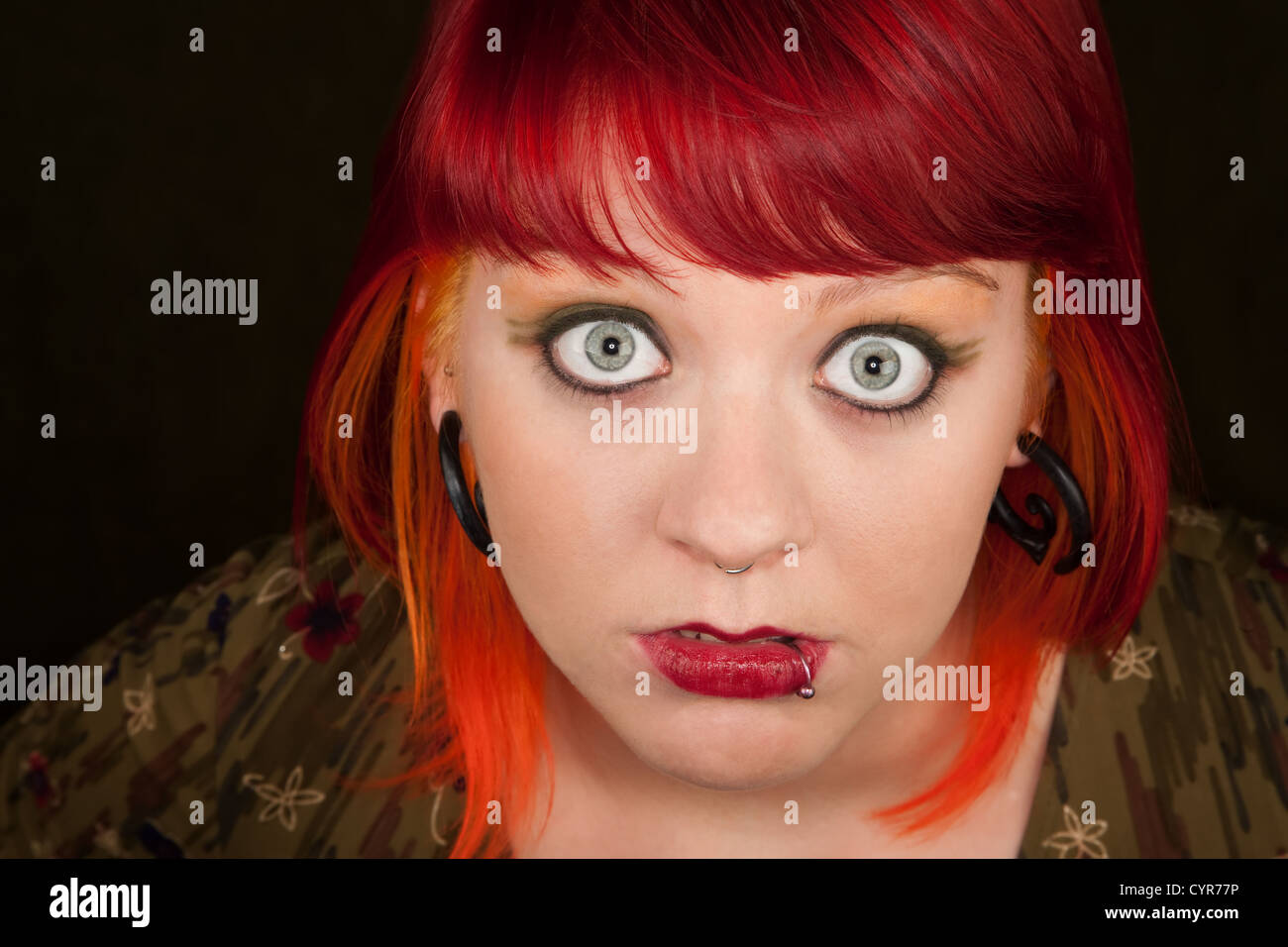 Pretty punky girl with brightly dyed red hair Stock Photo - Alamy