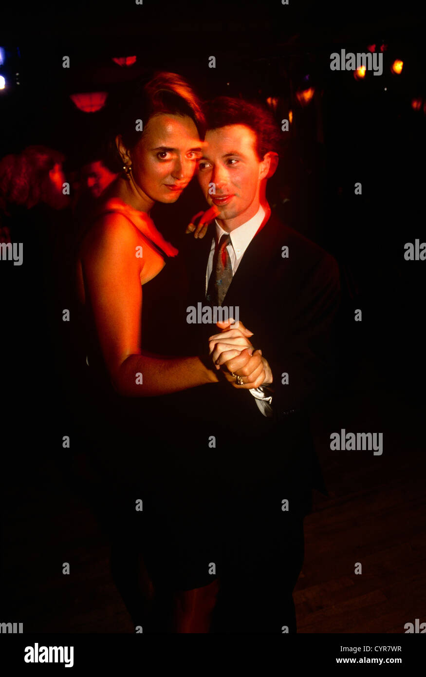 Young couple dance on the floor during an evening party hosted by the ...