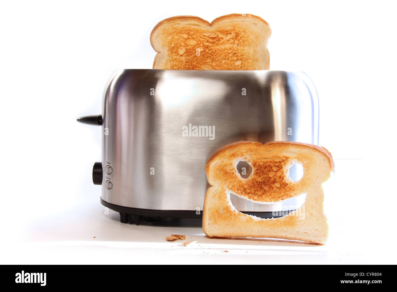 Toaster with slices of toast on a sunny lit background Stock Photo - Alamy