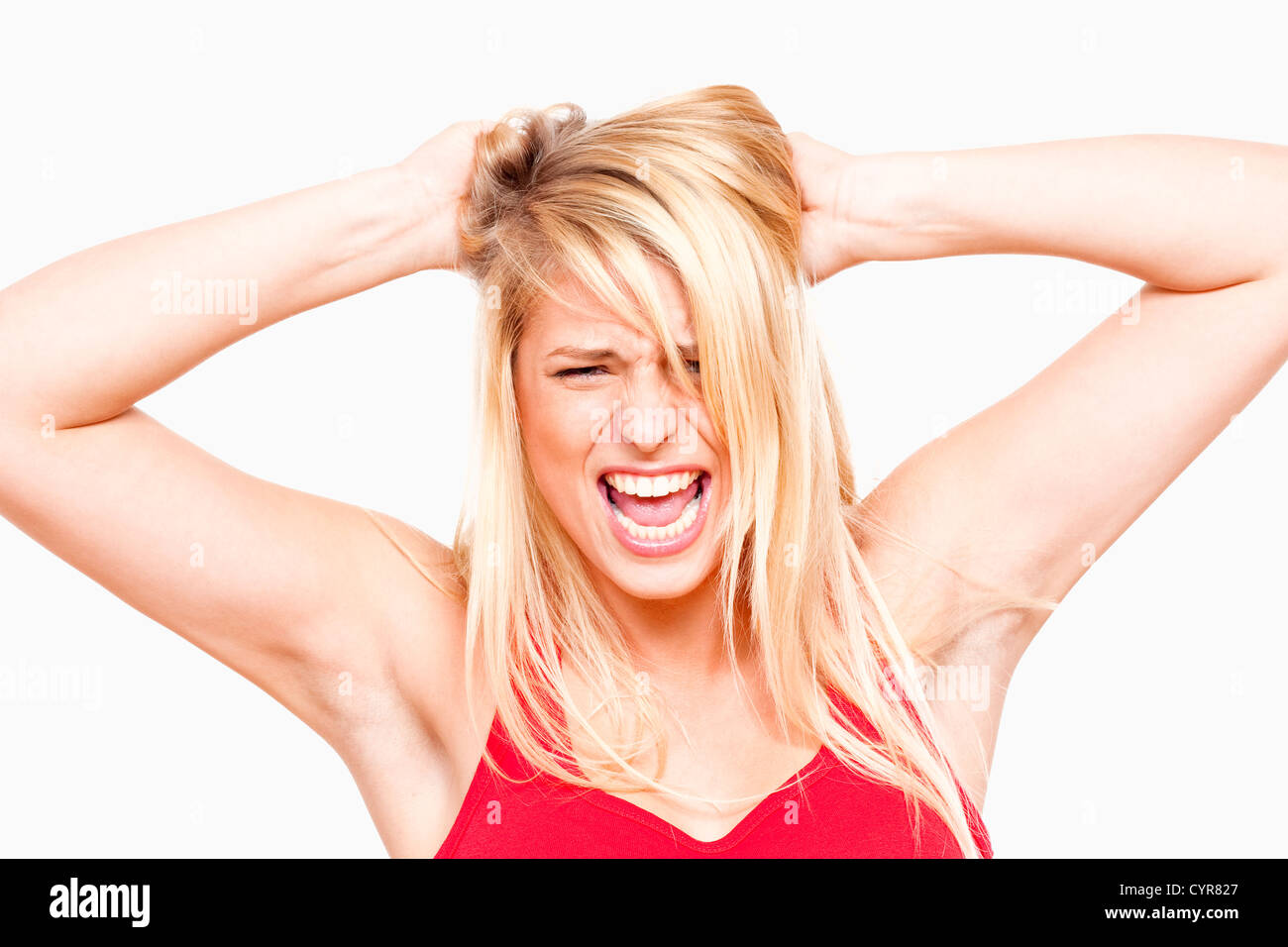 angry, frustrated girl with hands in her hair screaming - isolated on ...