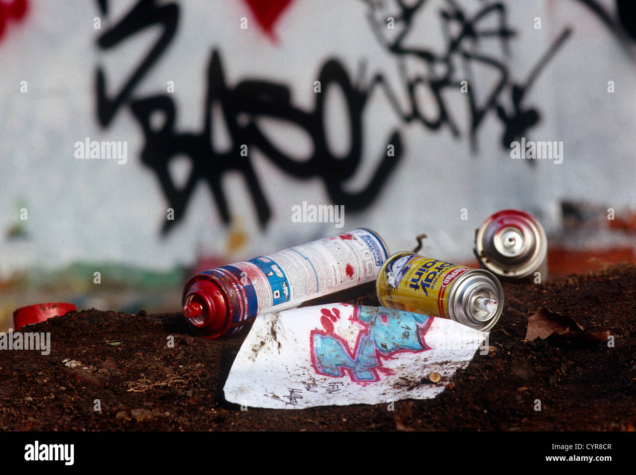 Abandoned aerosol spray cans lie in soil after a graffiti gang's ...