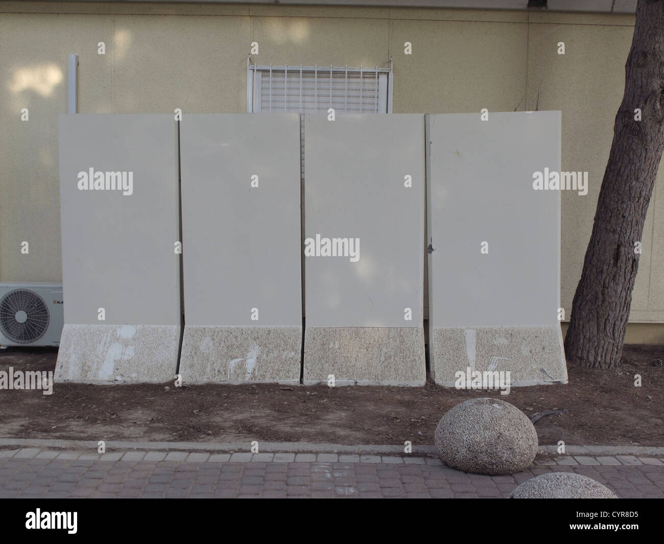 T-shaped portable, steel-reinforced concrete blast wall placed in front ...