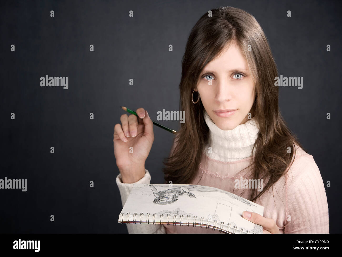 Pretty female artist with pencil and drawing pad Stock Photo - Alamy