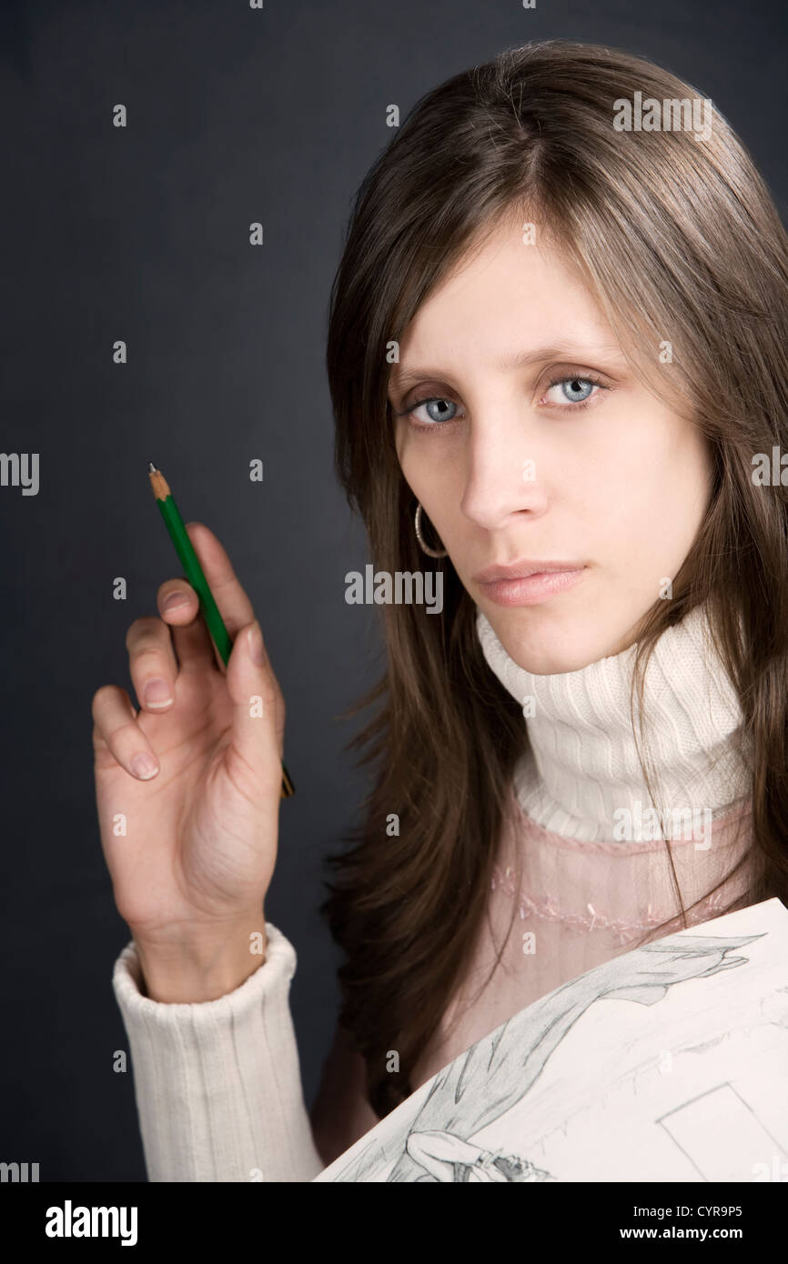 Pretty female artist with pencil and drawing pad Stock Photo - Alamy