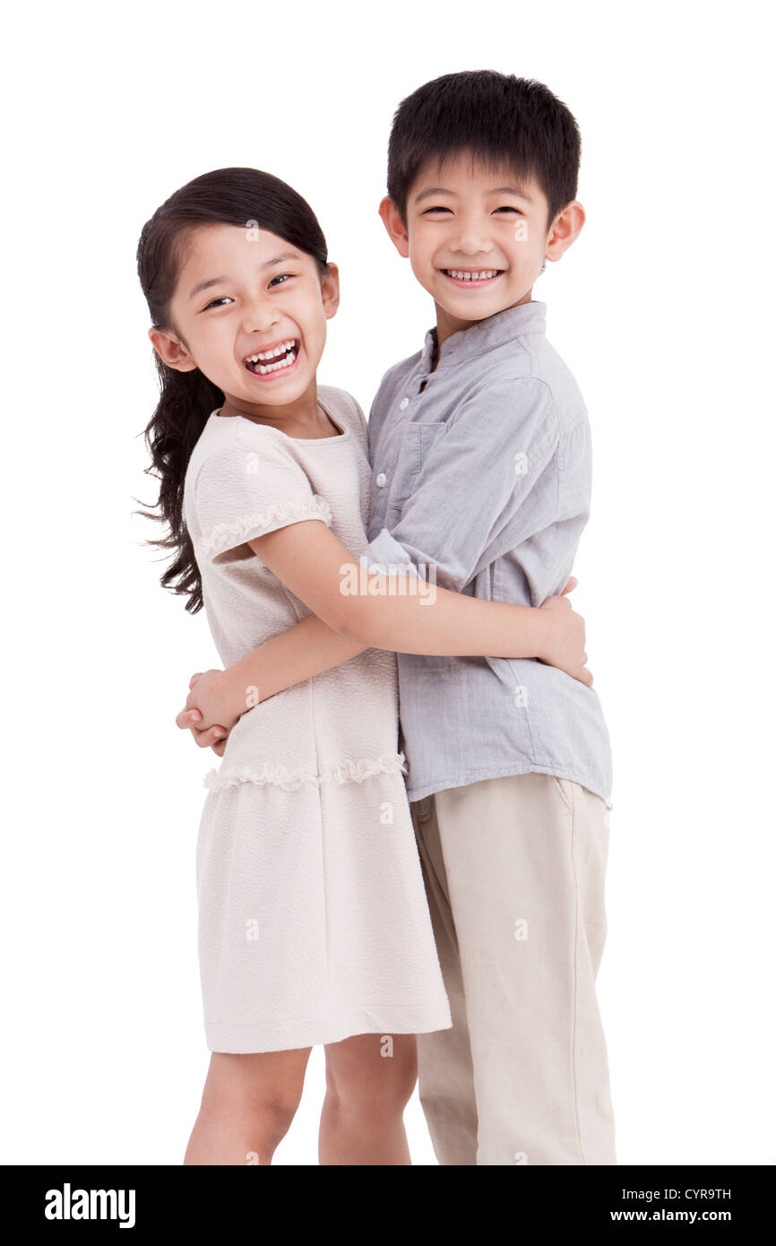 Happy little girl and boy embracing Stock Photo - Alamy