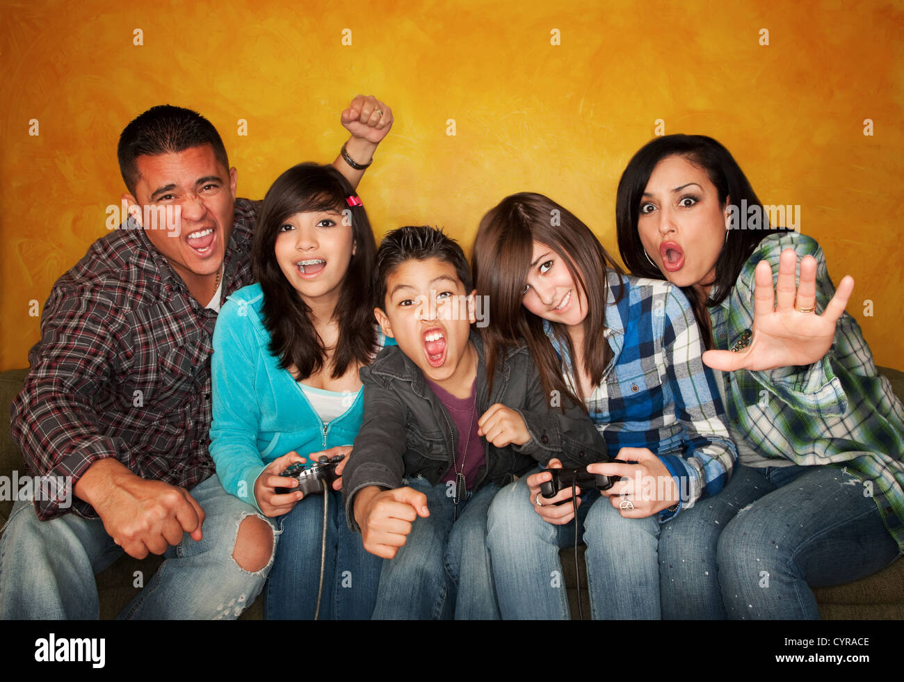 Attractive Hispanic Family on Couch Playing a Video Game Stock Photo ...