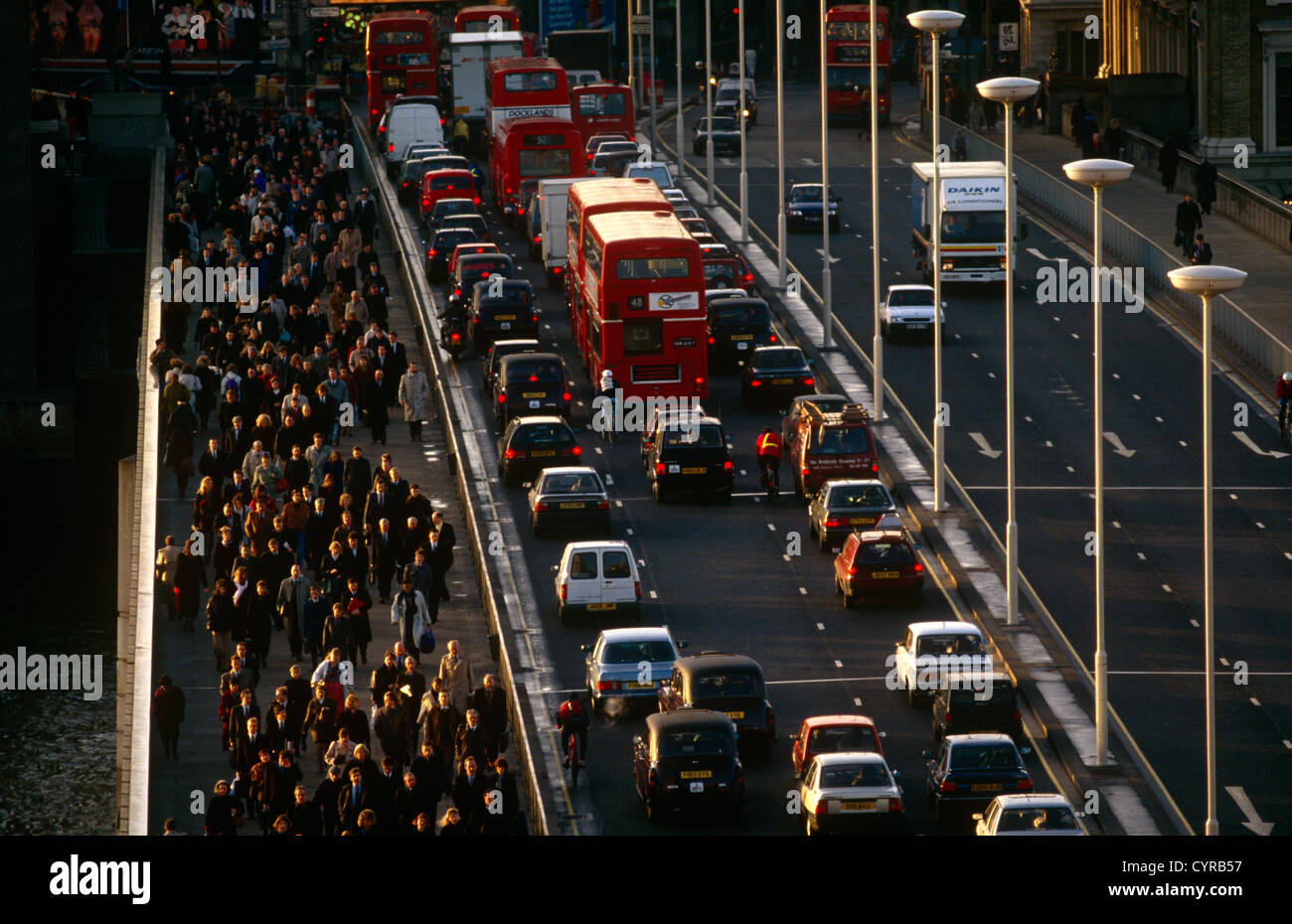Thousands of commuters pour northwards over London Bridge against the ...