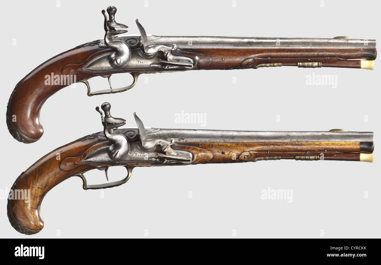 A pair of German flintlock pistols, circa 1760. Smooth bore barrels ...