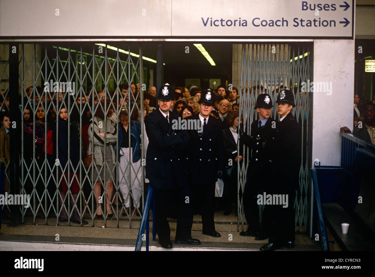 Metropolitan police officers stand guarding a closed underground tube ...
