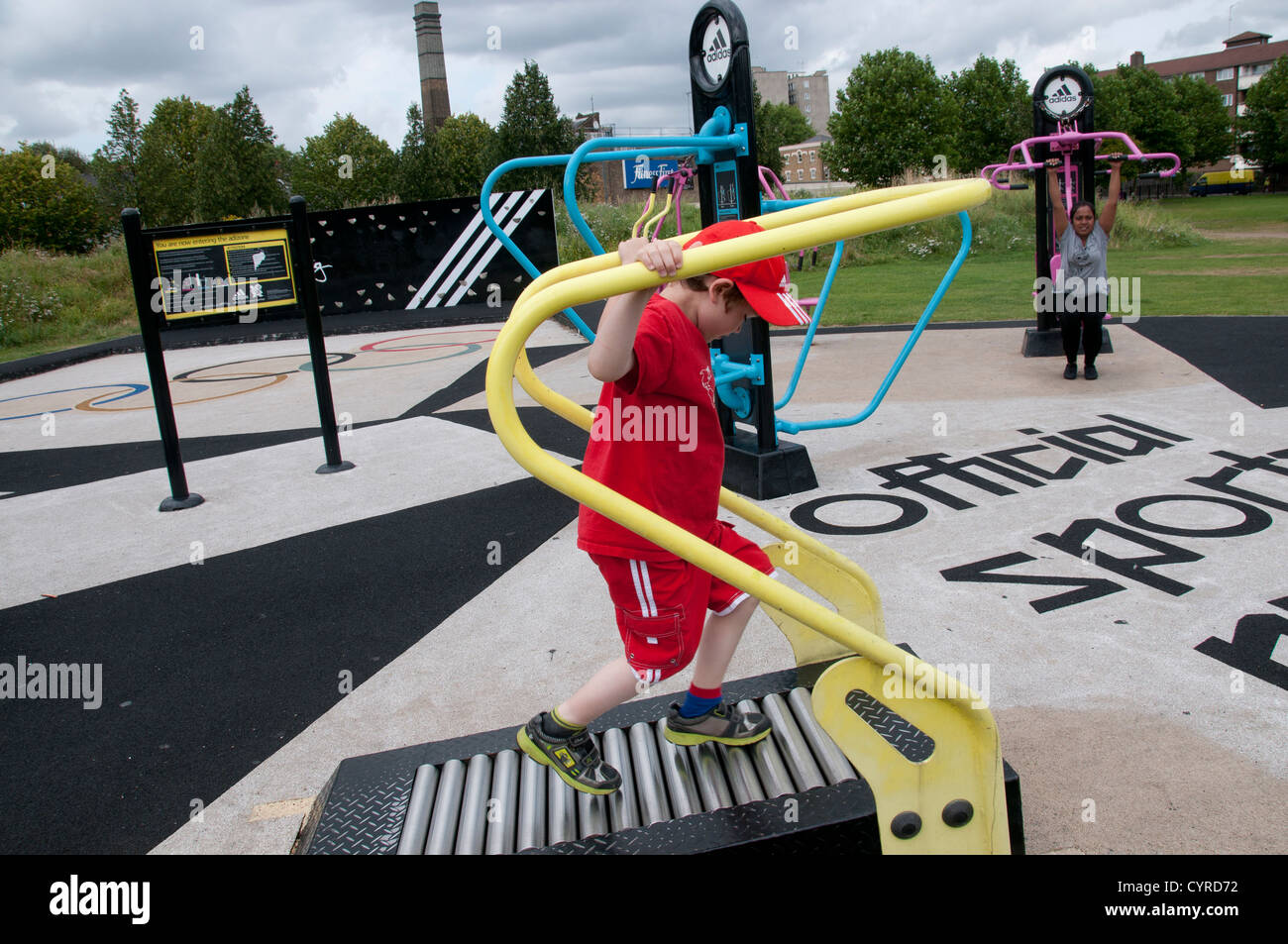 East London. Mile End Park . Keep fit apparatus. Young boy on running ...