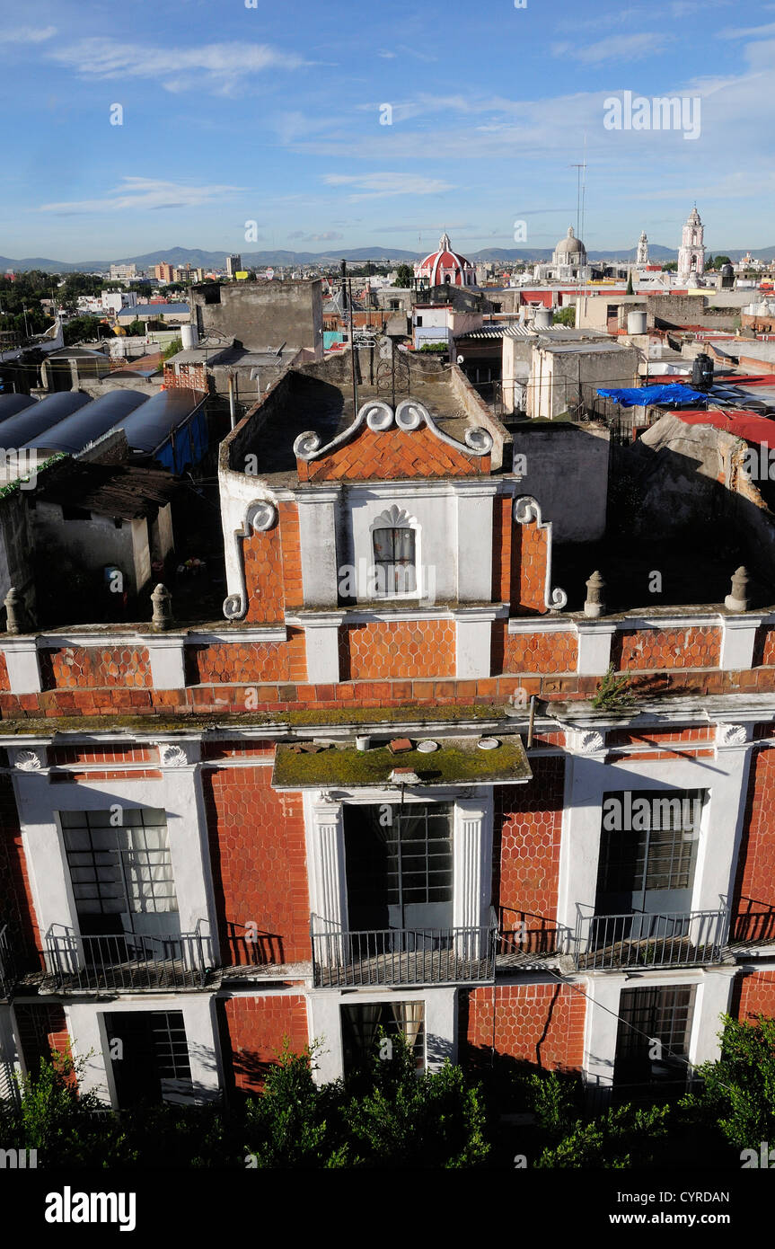 View across city rooftops with red brick and white facade of building ...
