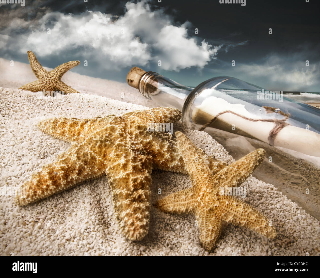 Message in a bottle buried in sand on a beach Stock Photo - Alamy