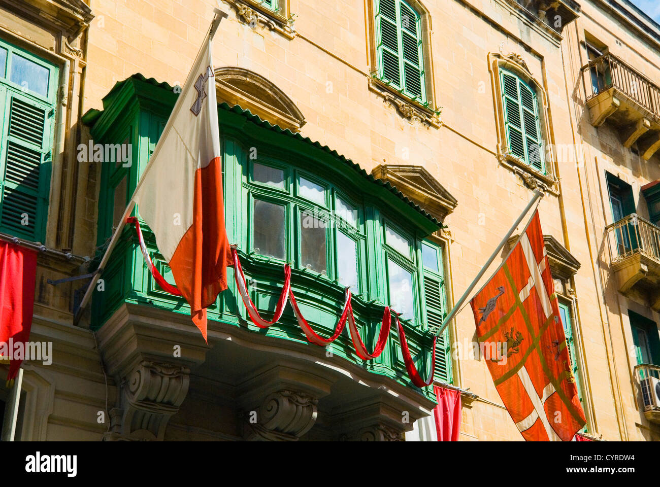 Two flags attached on window of a building, Valletta, Malta Stock Photo ...