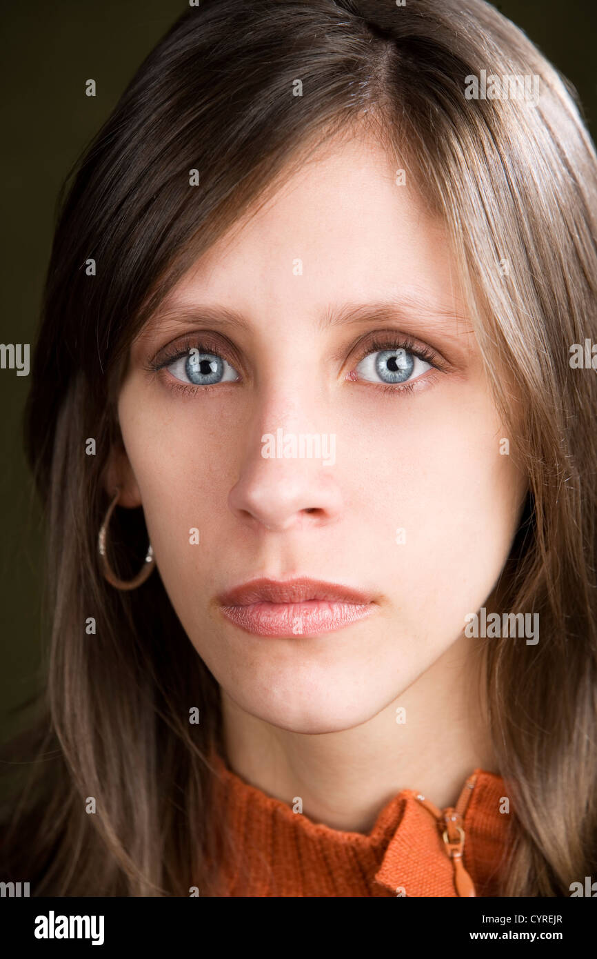 Pretty young woman with a blank expression on her face Stock Photo - Alamy