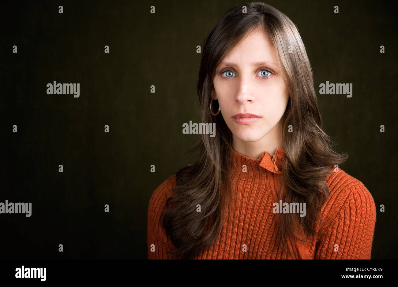 Pretty young woman with a blank expression on her face Stock Photo - Alamy