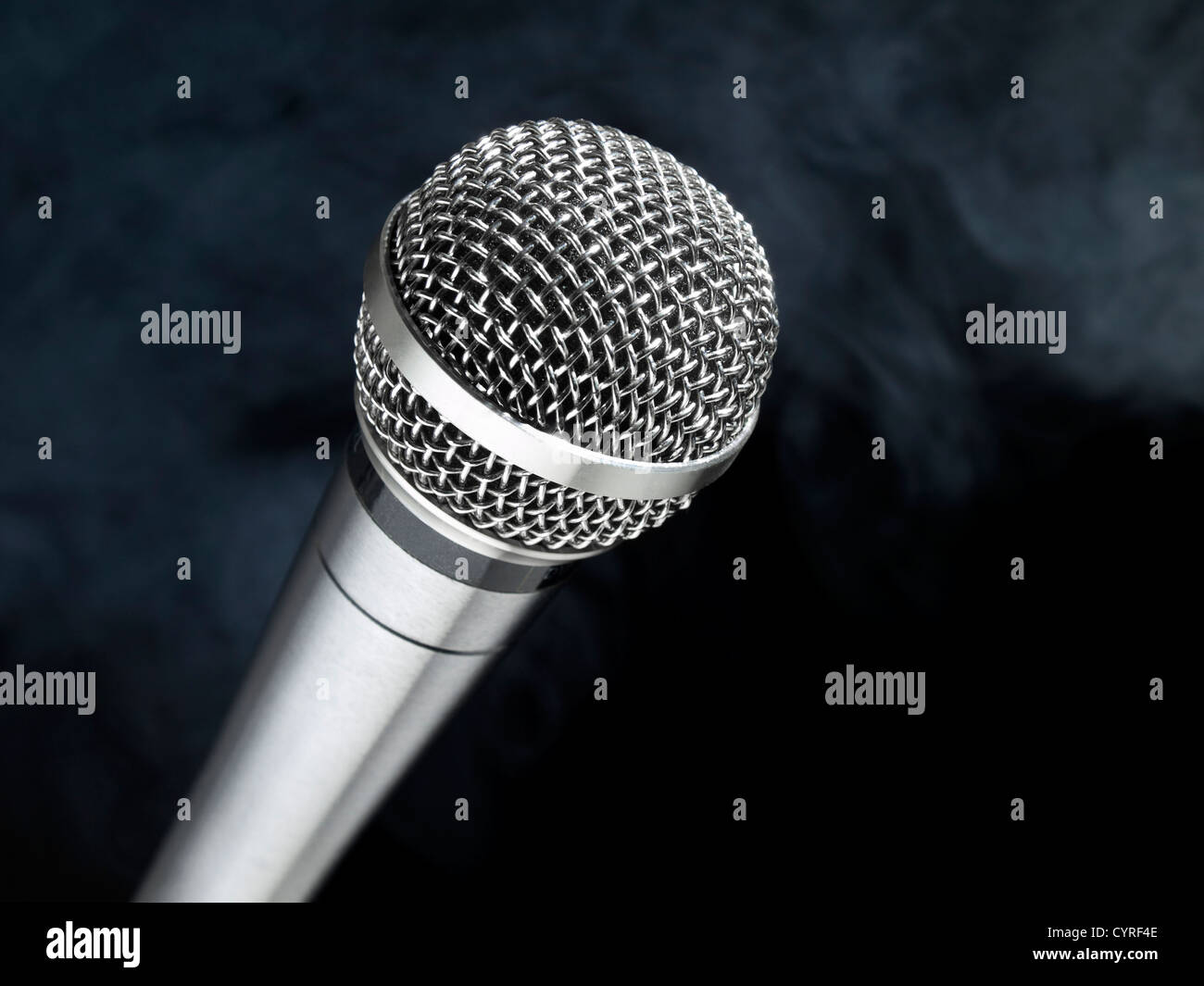 A dynamic microphone over a black and smoky background Stock Photo - Alamy