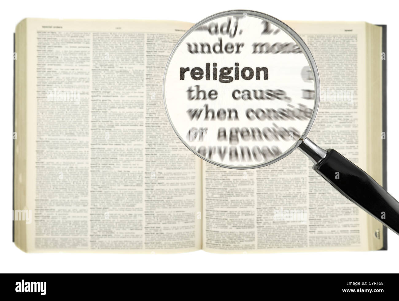 A magnifying glass on the word RELIGION on a dictionary Stock Photo - Alamy
