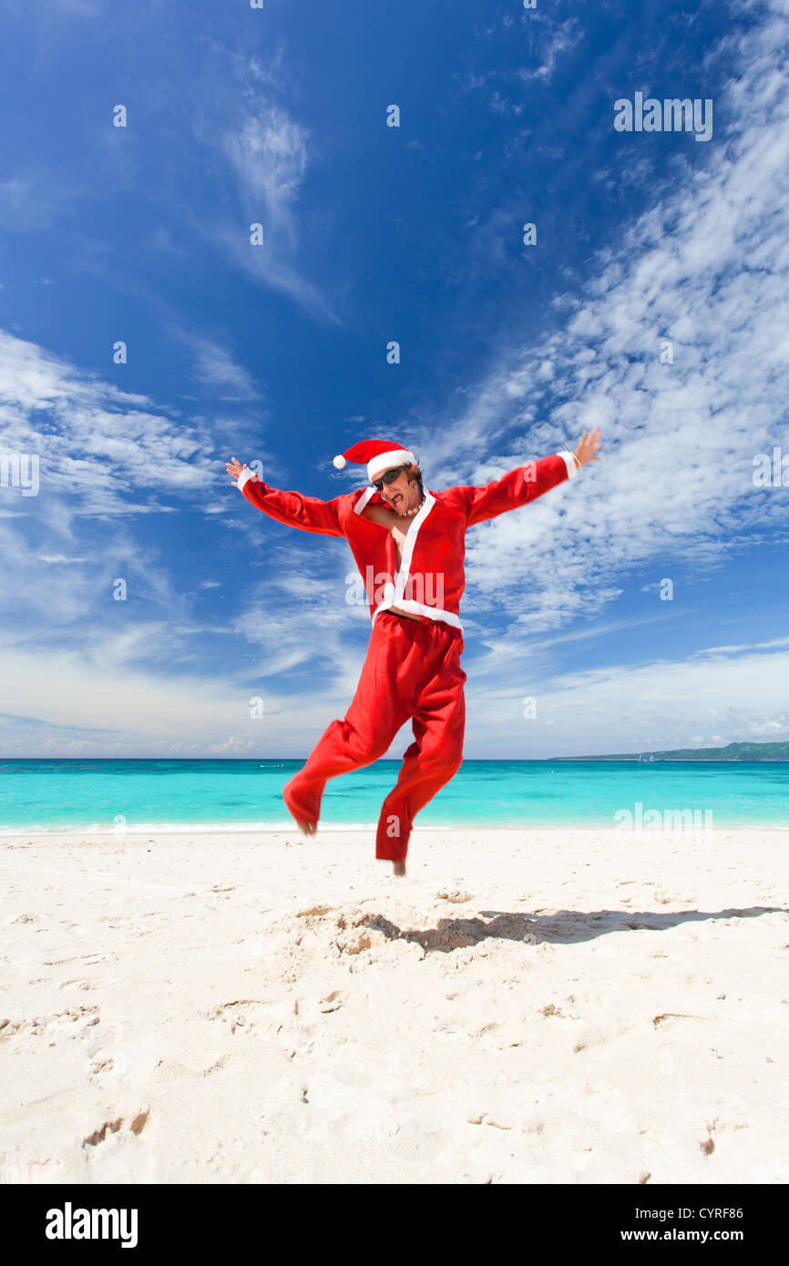 Santa Claus jumping on the beach Stock Photo - Alamy