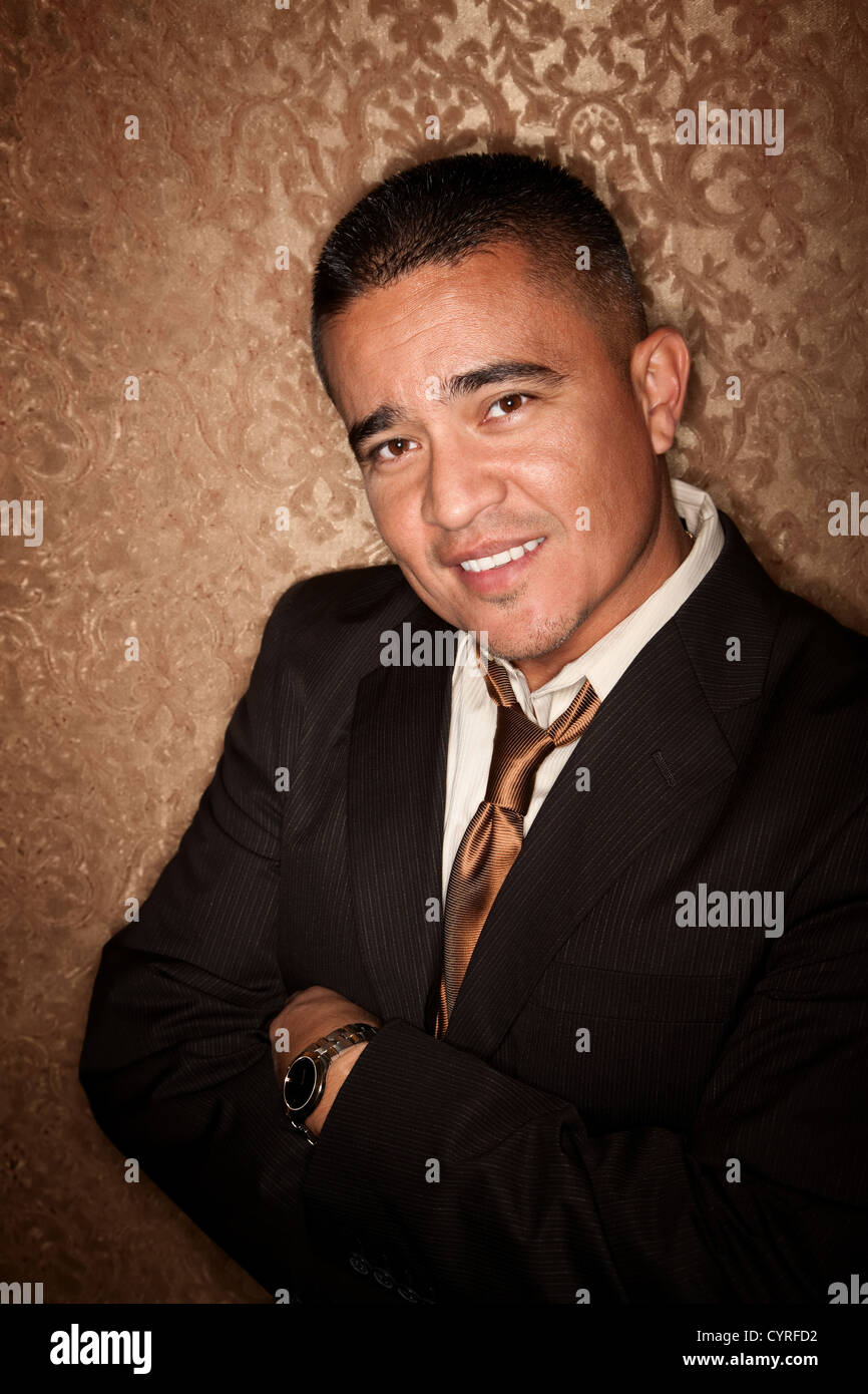 handsome Hispanic Man with Arms Crossed on Gold background Stock Photo ...