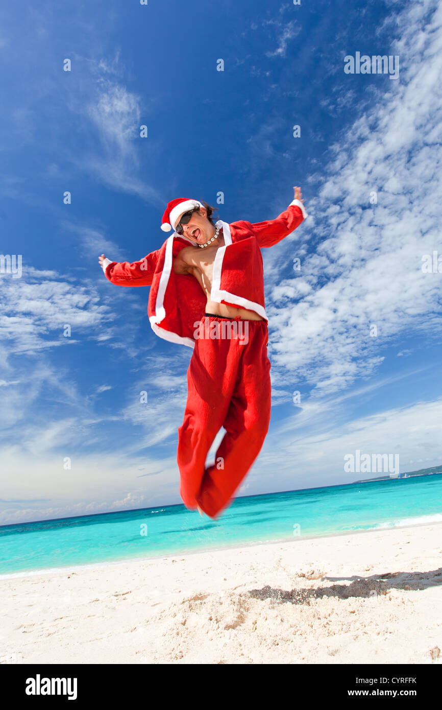 Santa Claus jumping on the beach Stock Photo - Alamy