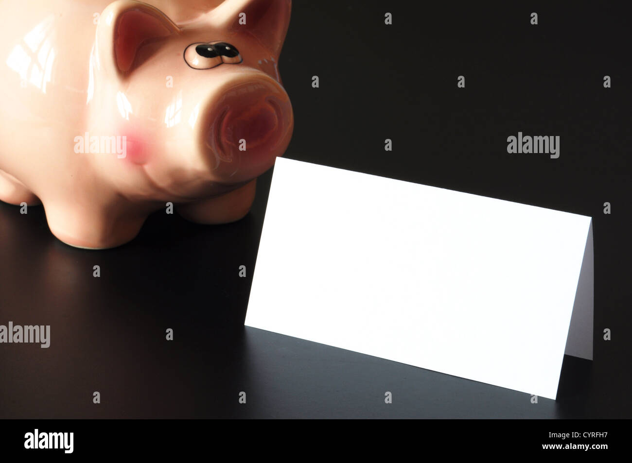 piggy bank and blank sheet of paper with copyspace for text message ...