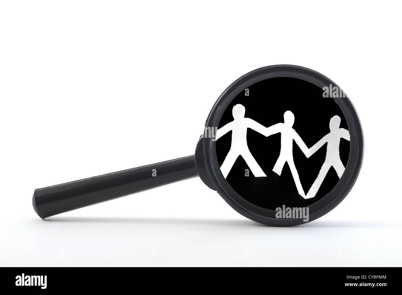 magnifying glass and team of paper man showing teamwork Stock Photo - Alamy