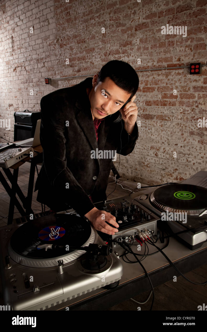Handsome Asian DJ With Turntable and Headphones Stock Photo - Alamy