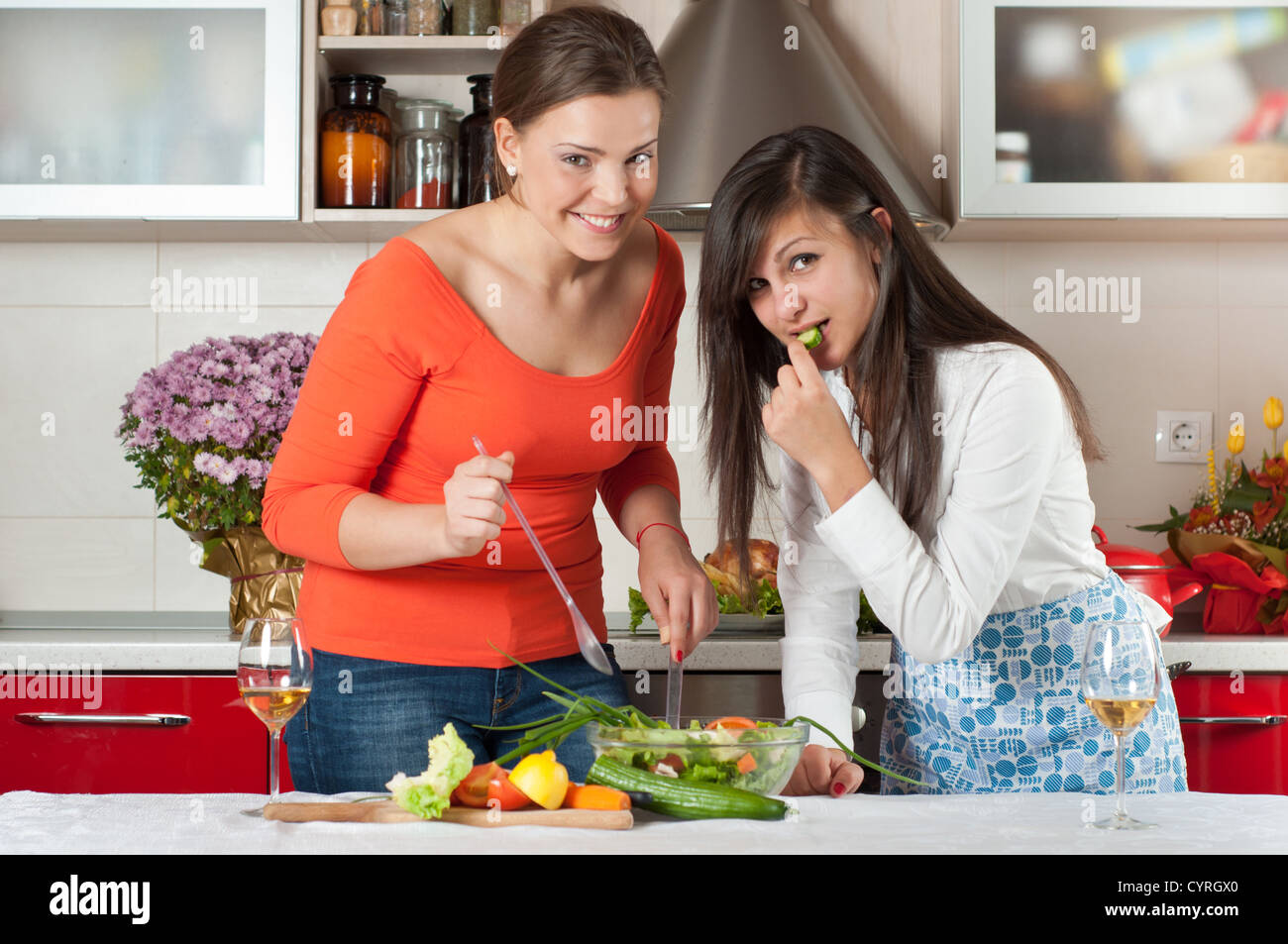 two friends cooking together dinner salad Stock Photo - Alamy
