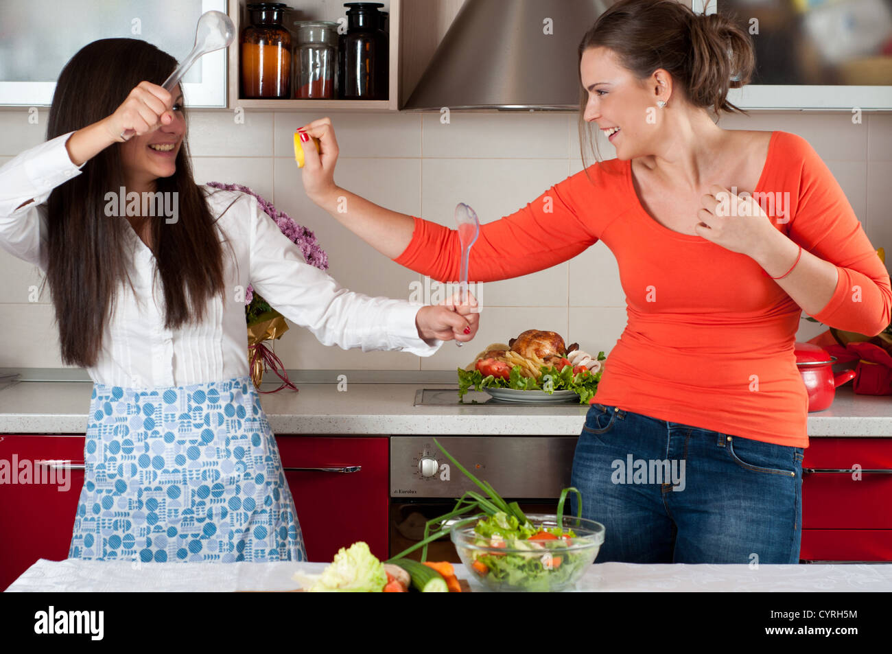 two friends cooking together dinner salad Stock Photo - Alamy