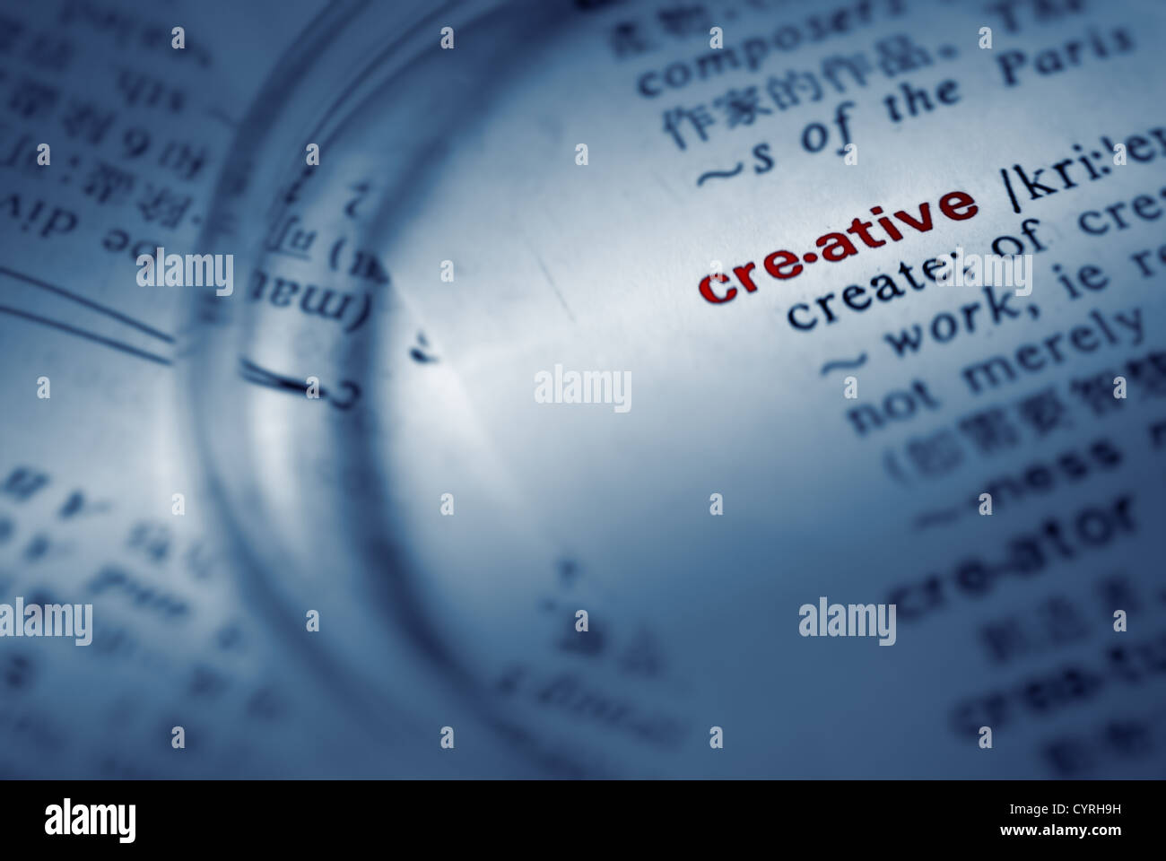 Find creative definition from book by magnifier Stock Photo - Alamy