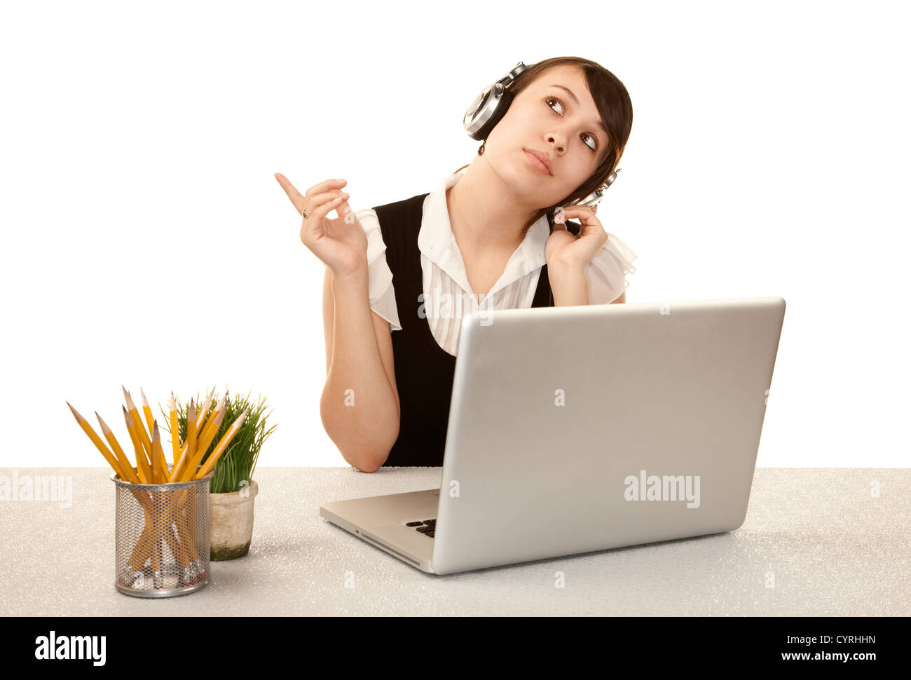 Pretty female office worker with laptop computer and headphones Stock ...