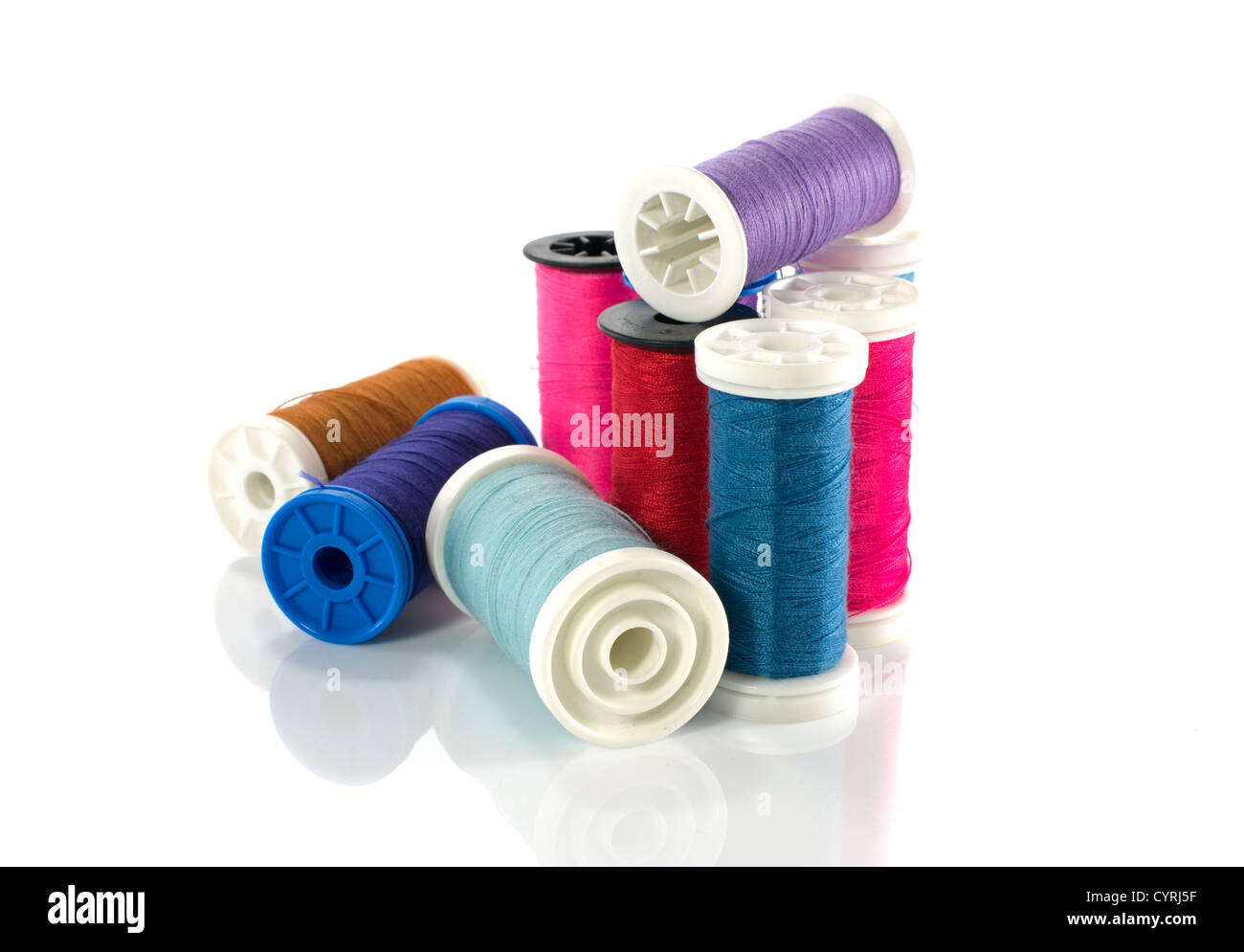 stack of coloured sewing thread isolated on white Stock Photo - Alamy