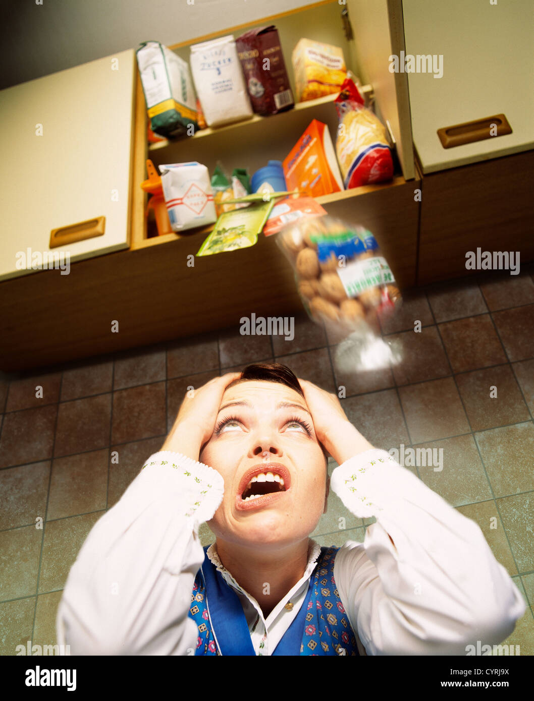 kitchen nightmare. women is standing in the kitchen under a board an is ...