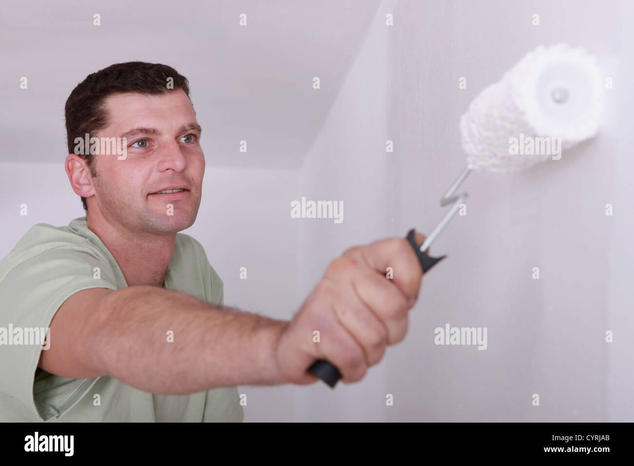 Painter with roller Stock Photo - Alamy