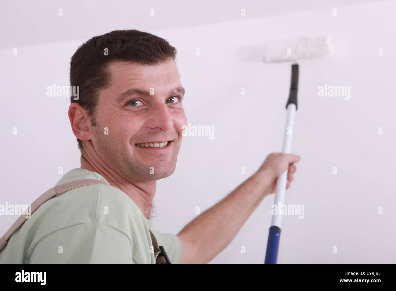 Painter with roller Stock Photo - Alamy