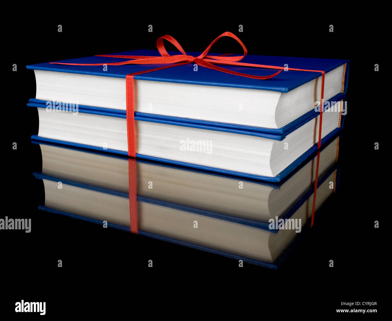 Two blue books with red silk ribbon, isolated on black background Stock ...