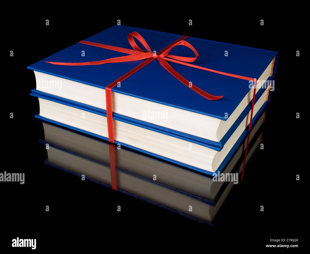 Two blue books with red silk ribbon, isolated on black background Stock ...