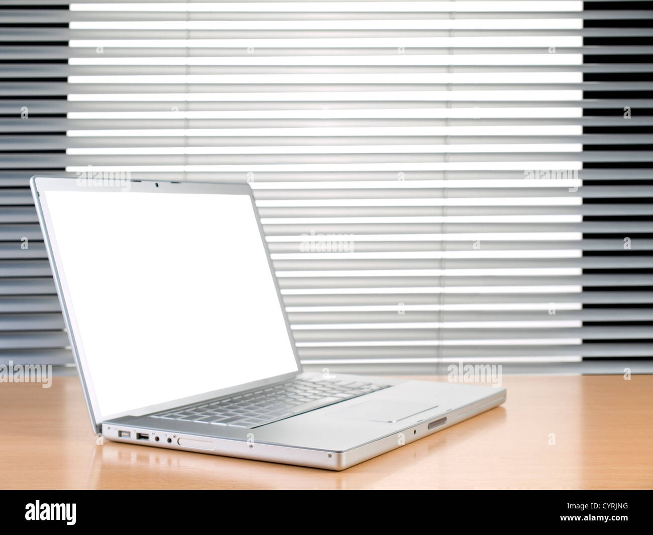 A laptop on a table at a modern office Stock Photo - Alamy