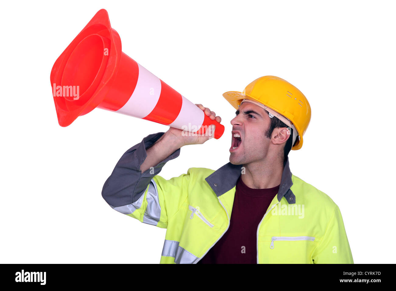 Manual worker shouting through cone Stock Photo - Alamy